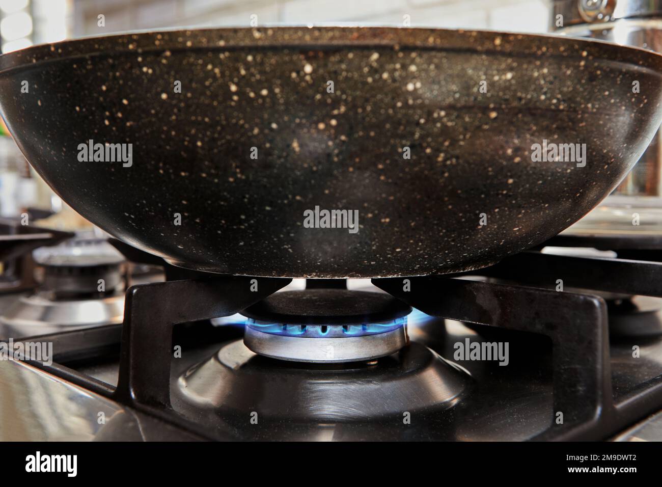 Frying pan on gas stove on fire with dish being prepared Stock Photo ...