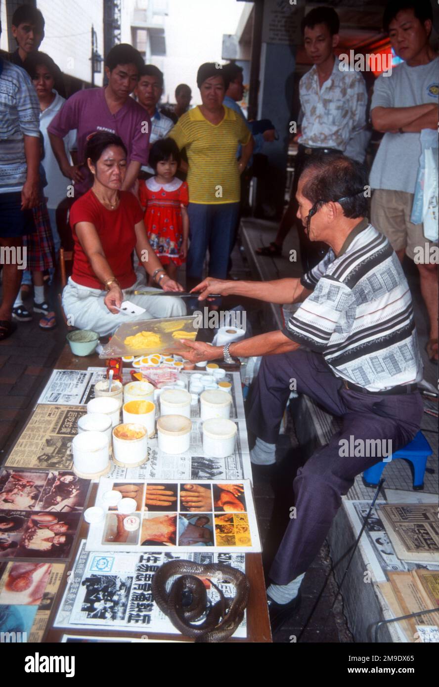 Street stall selling snake-fat cures in Singapore Stock Photo - Alamy