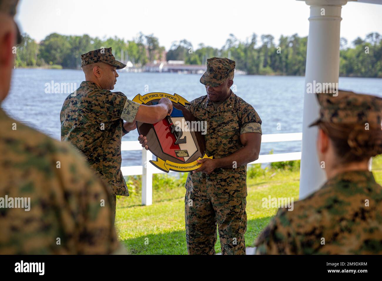 U.S. Marine Corps Col. David Everly presents a commemorative plaque to ...