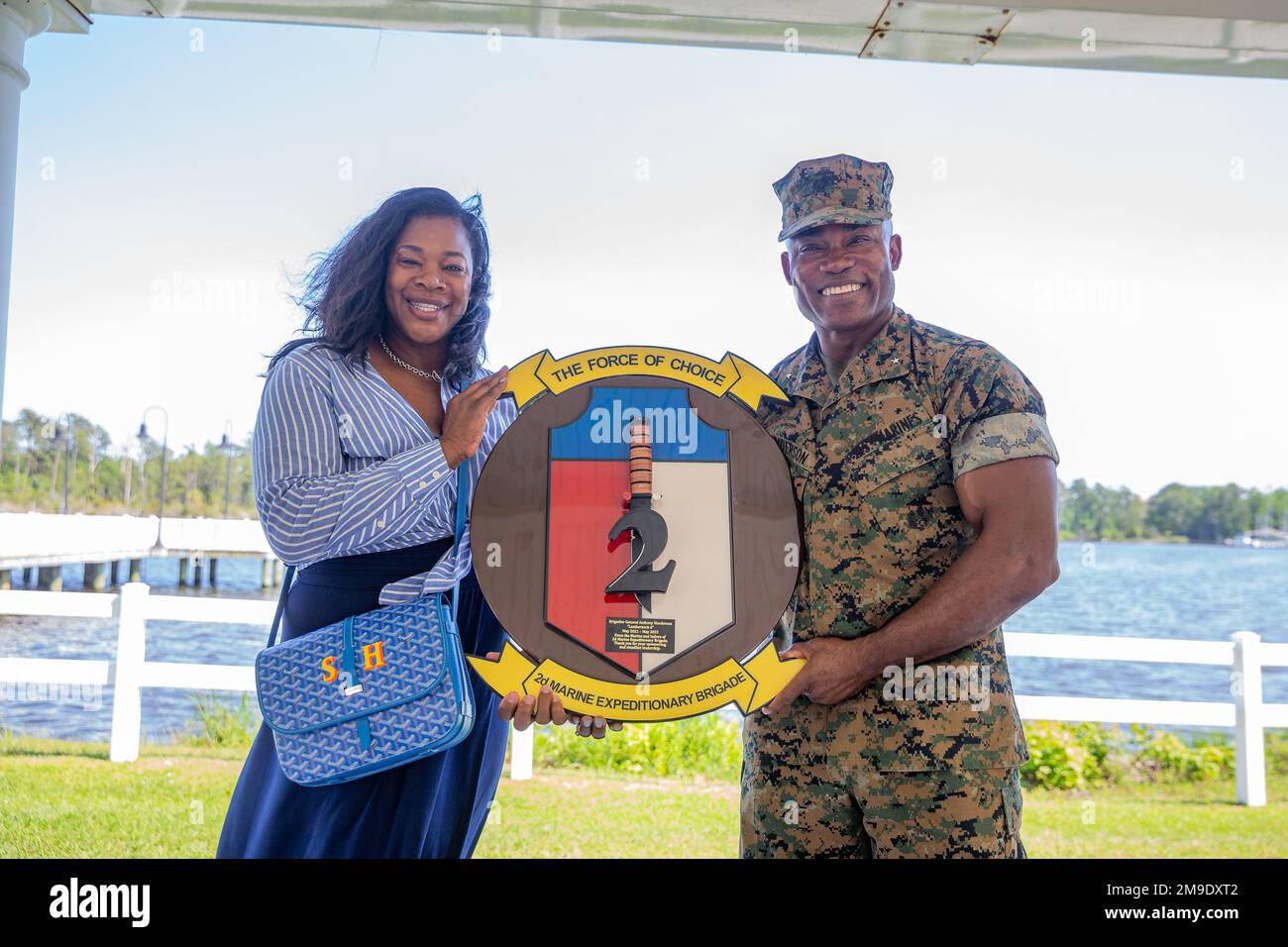 U.S. Marine Corps Col. David Everly presents a commemorative plaque to ...