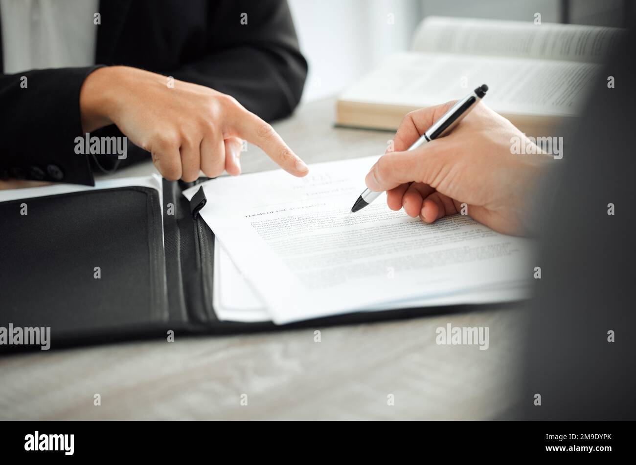 These should secure you the property. a lawyer helping a client sign a ...