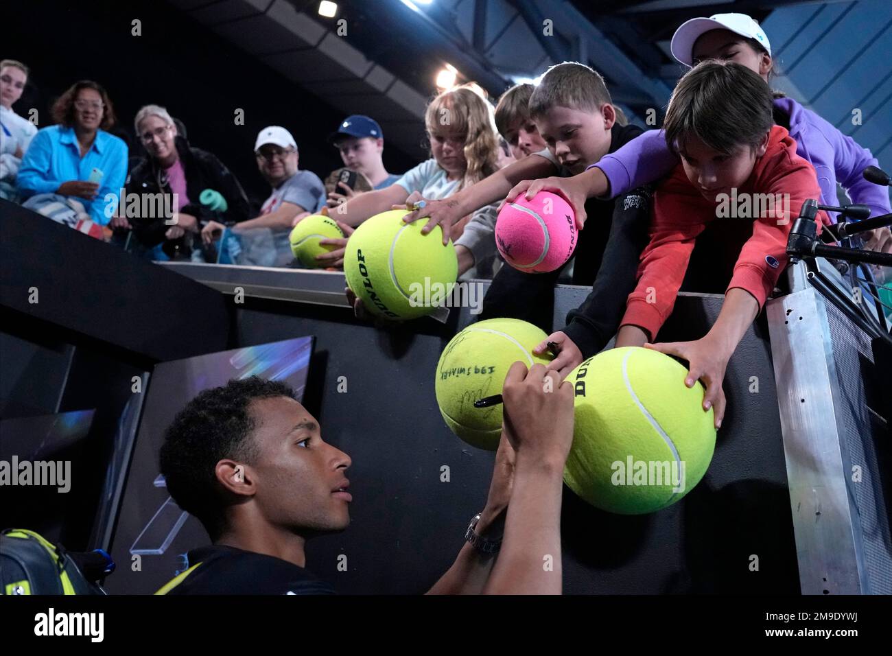 Felix Auger-Aliassime of Canada signs autographs after his second round ...