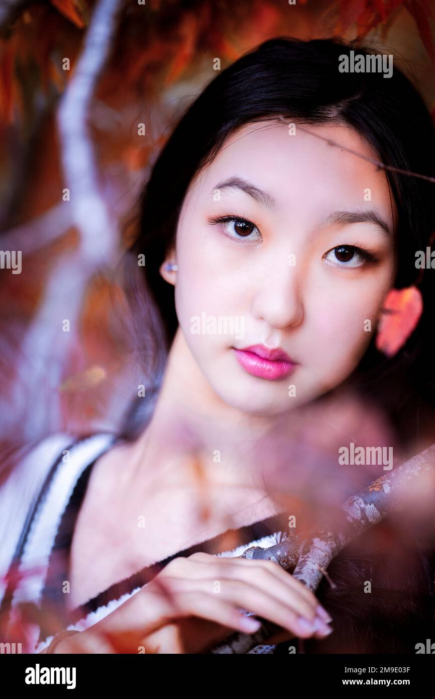 Close Up Portrait of Teenage Girl in a Maple Tree Surrounded by Leaves ...