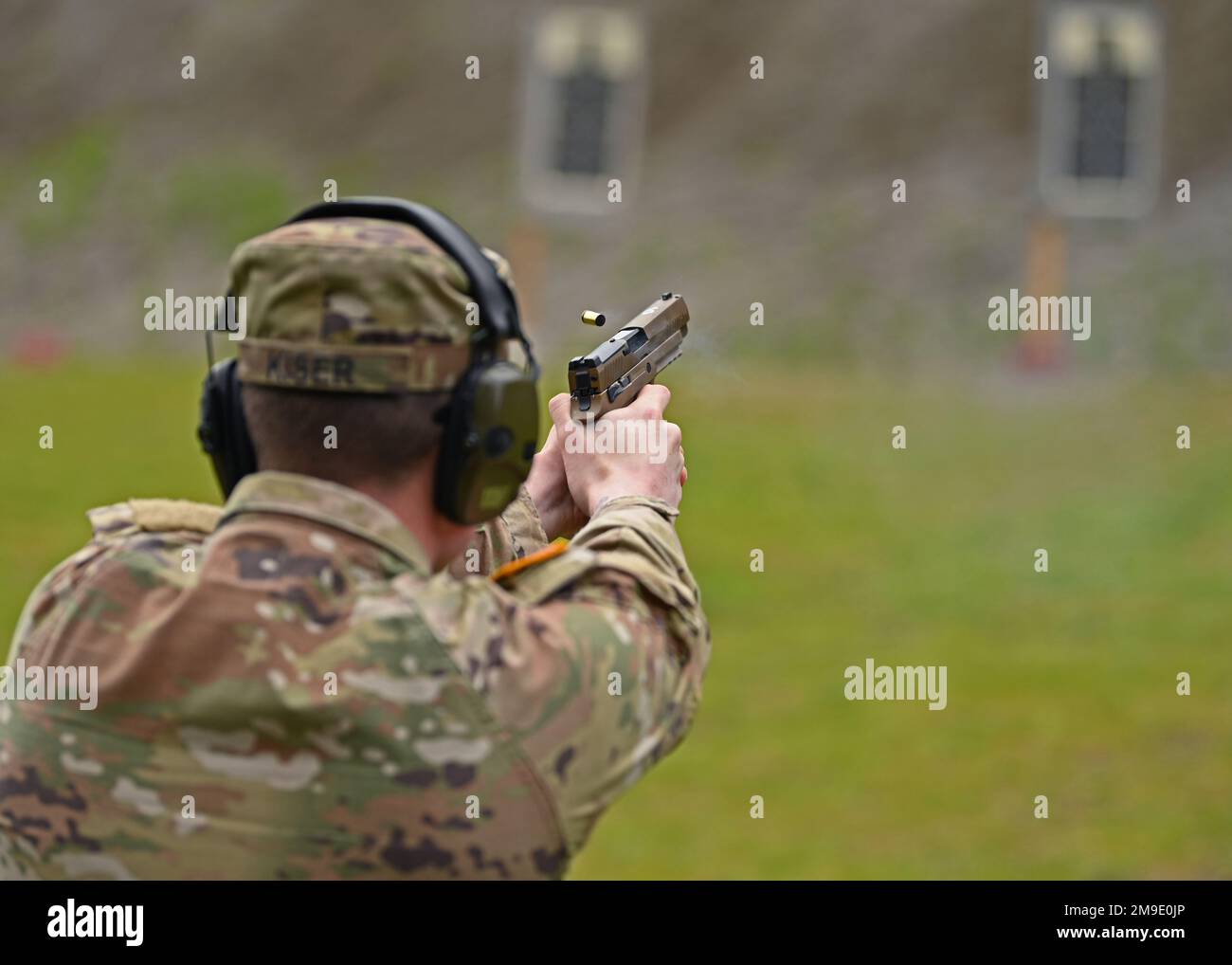A U.S. Soldier with the 42nd Military Police Brigade fires a pistol ...