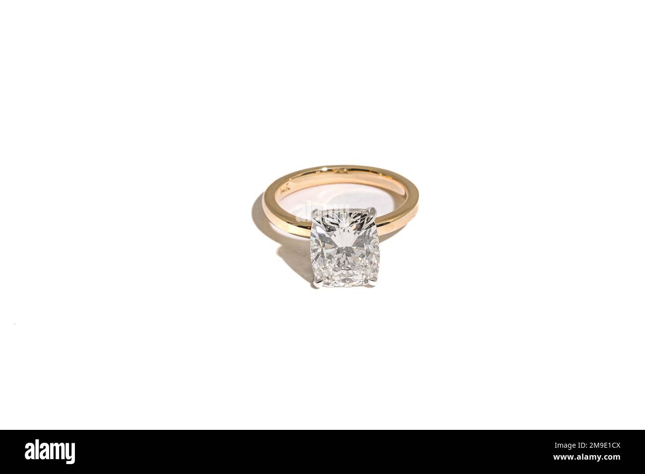 A closeup shot of a gold ring with diamond gem isolated on a white ...