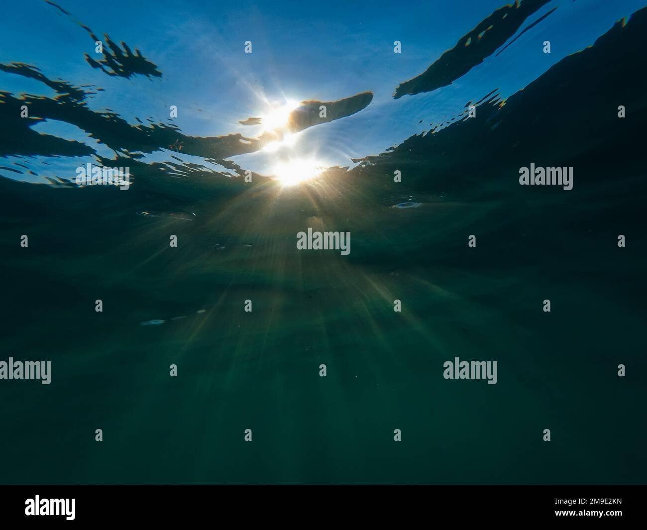 sunbeam Shine through the surface of the blue water at the depth of the ...
