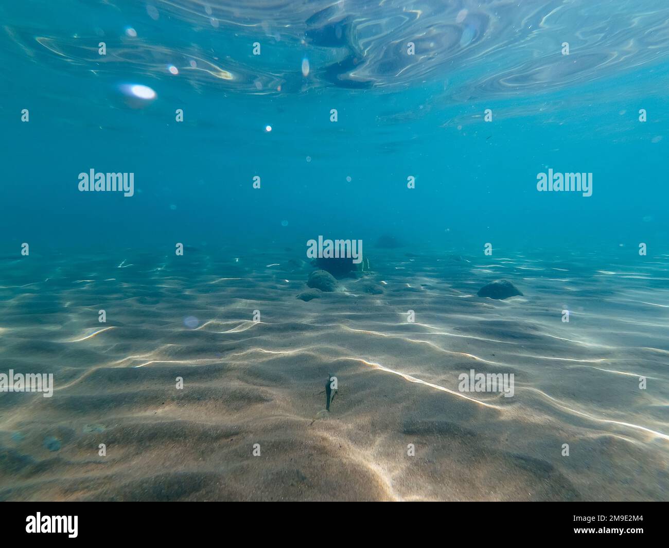 underwater world to the surface and the sand at the bottom on the beach ...