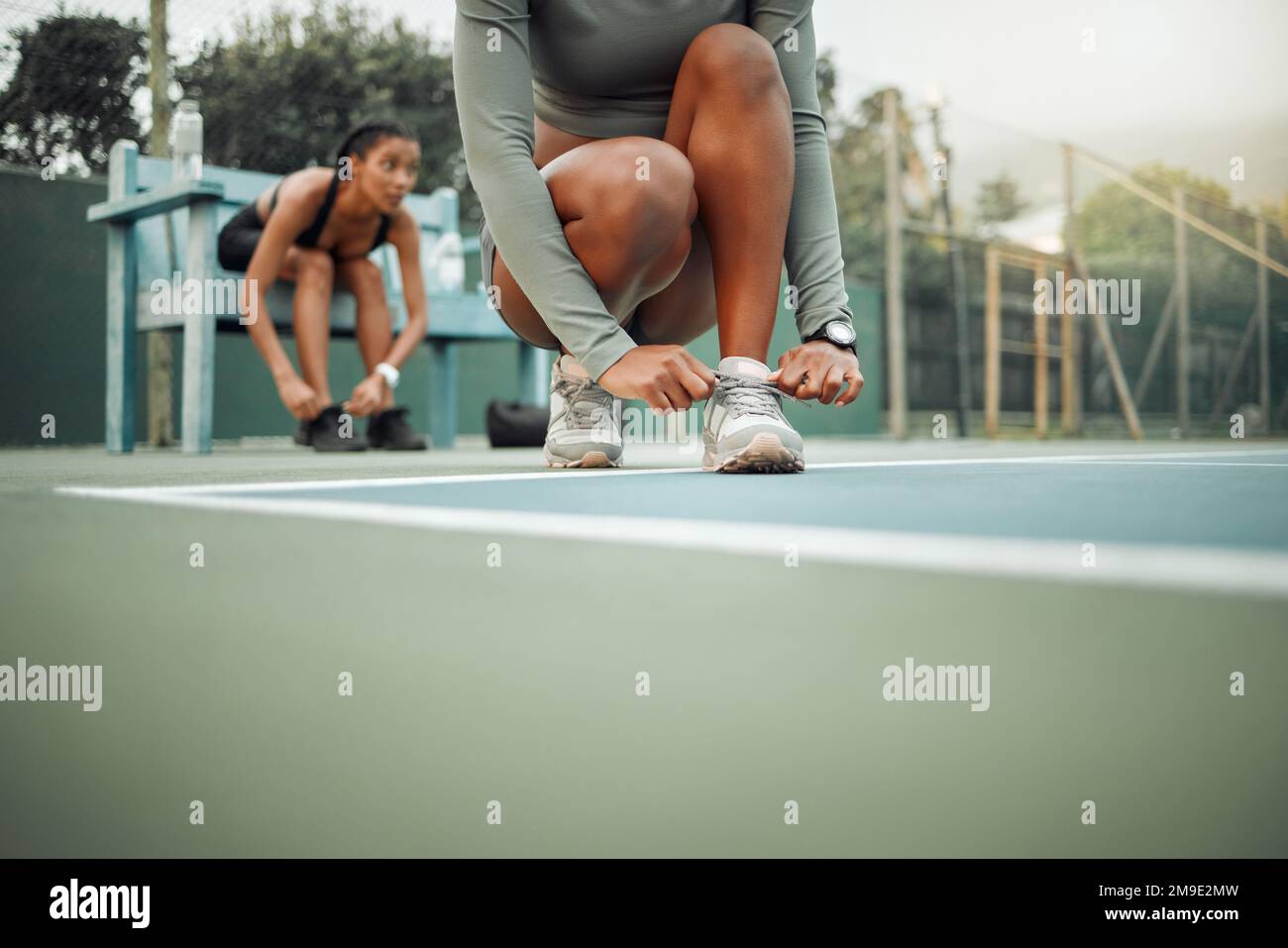 Preparation is key. an unrecognizable young female athlete tying her ...