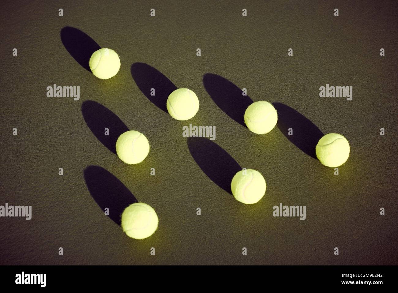 Lined up and ready to serve. tennis balls lying on a tennis court Stock ...