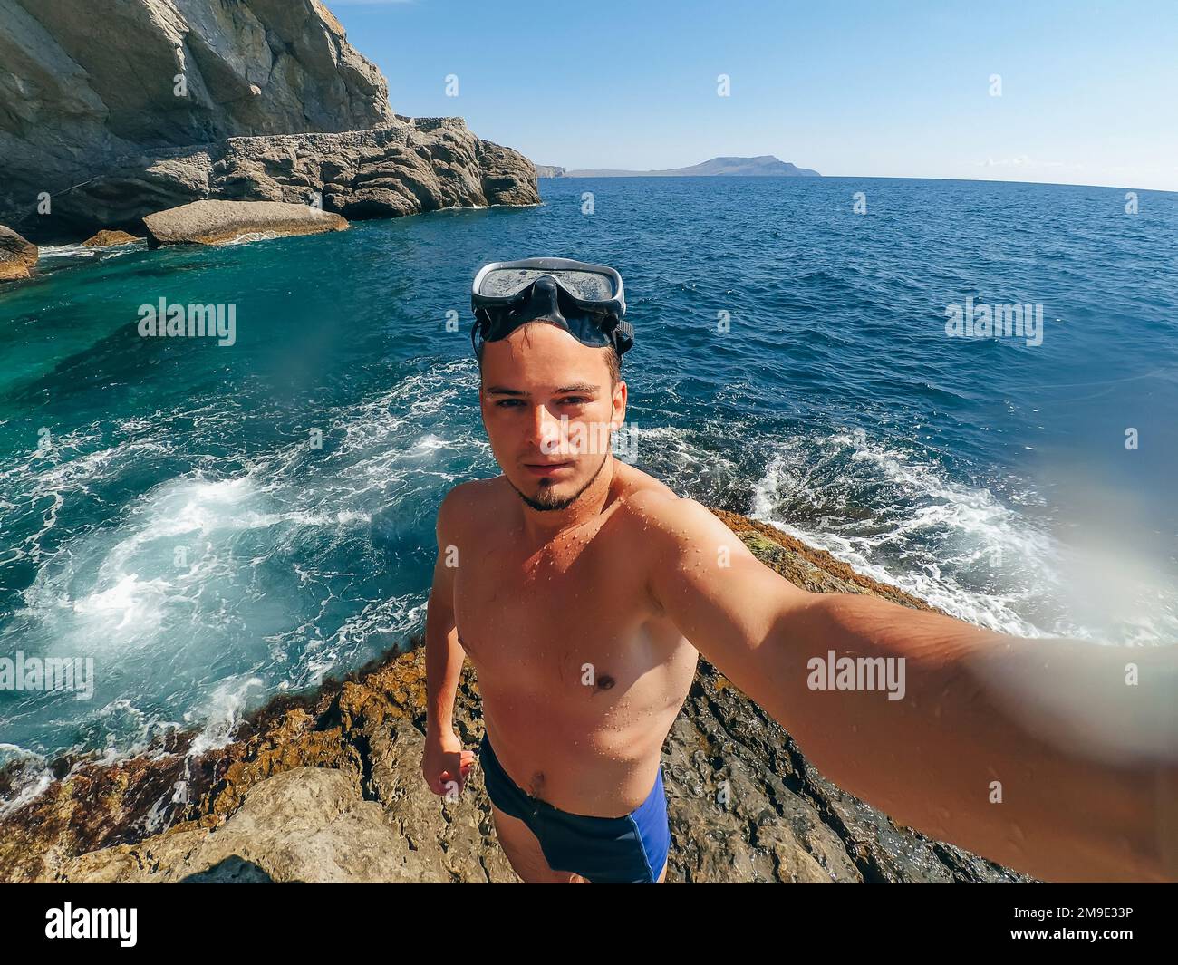 selfie sports men diver in the mask standing on the shore of the sea in ...
