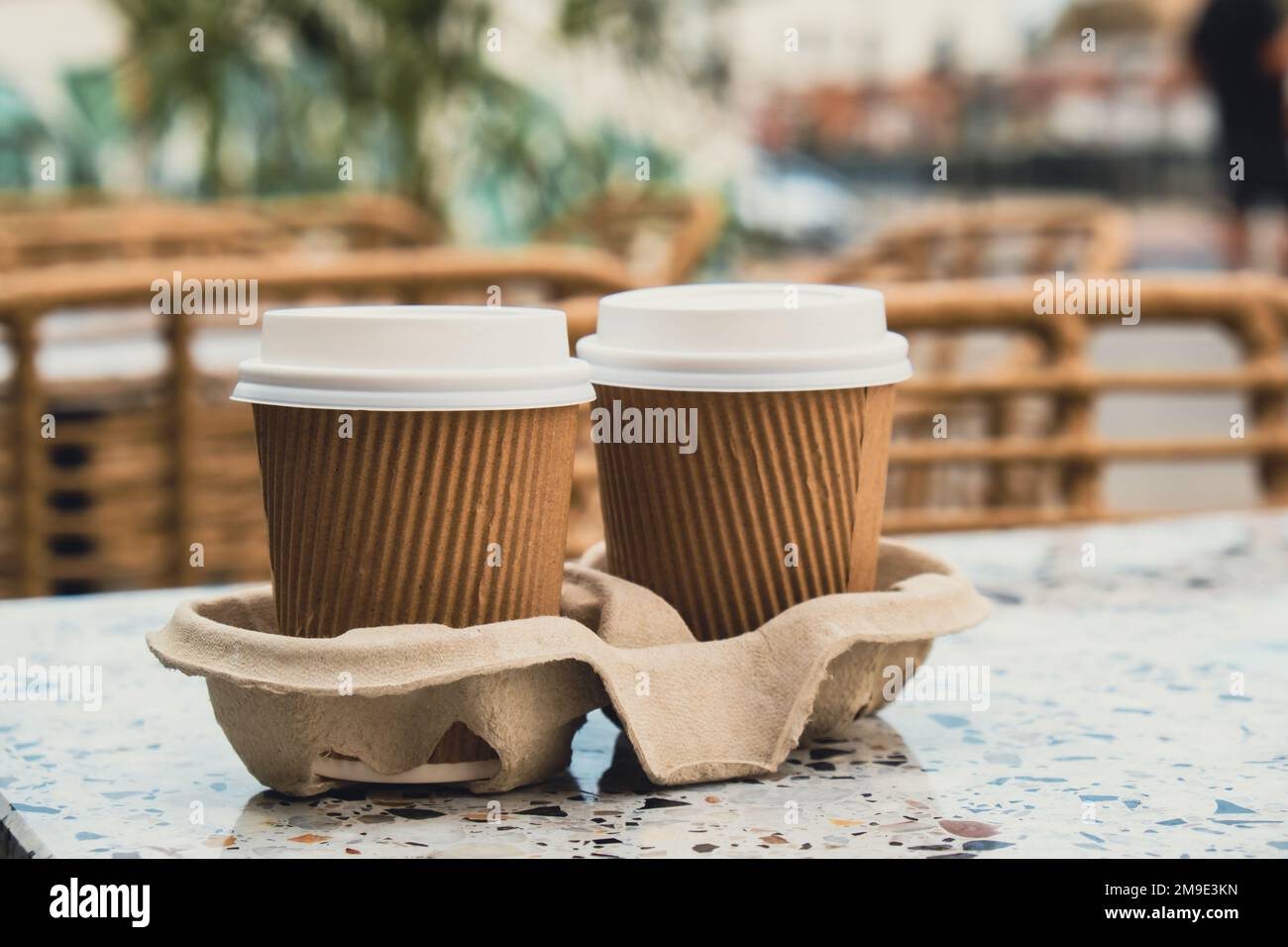 Two paper cups with lid for tea to go. Coffee take away on the table ...