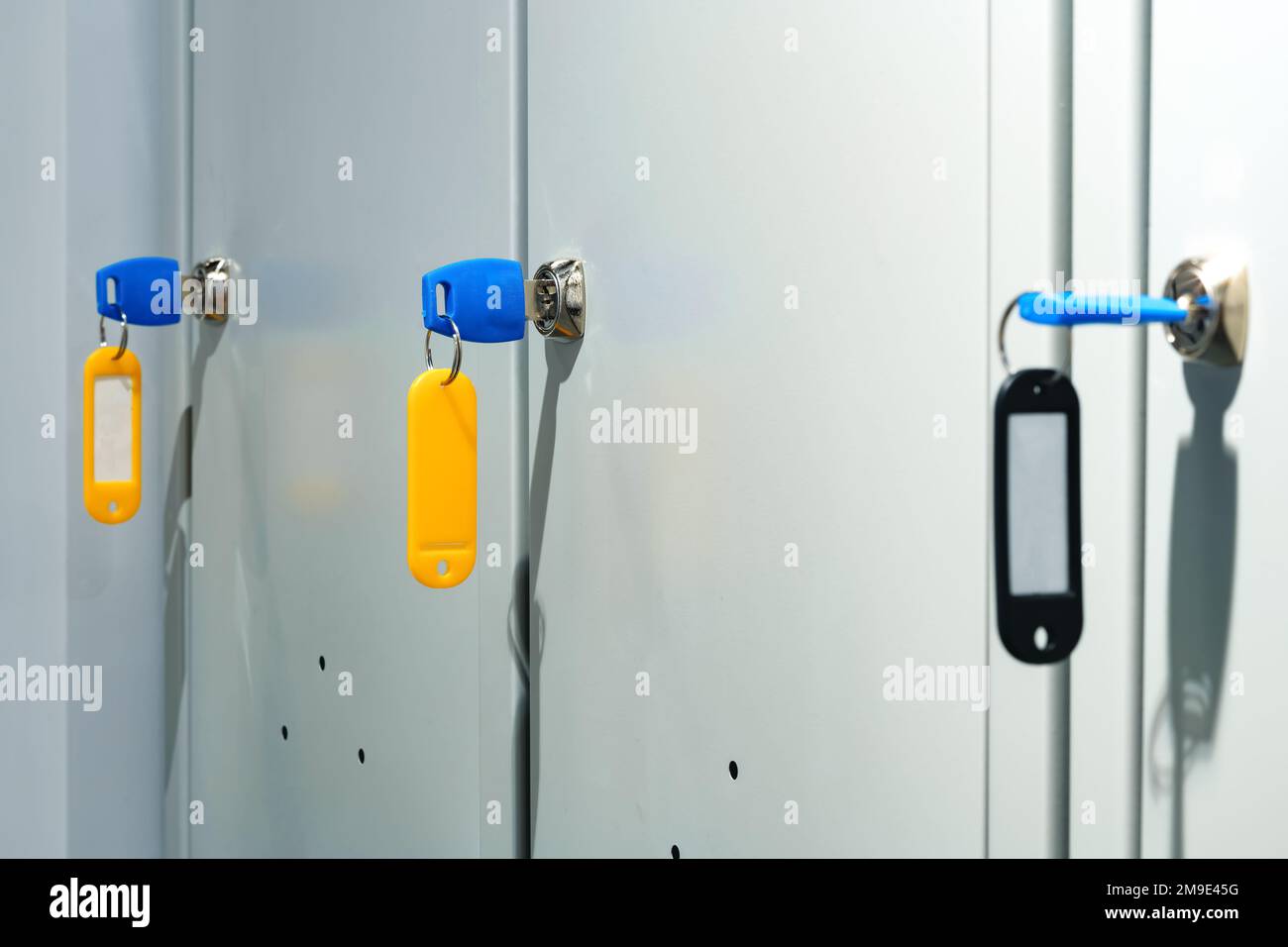 Gray locker with key for safety in public facility Stock Photo - Alamy