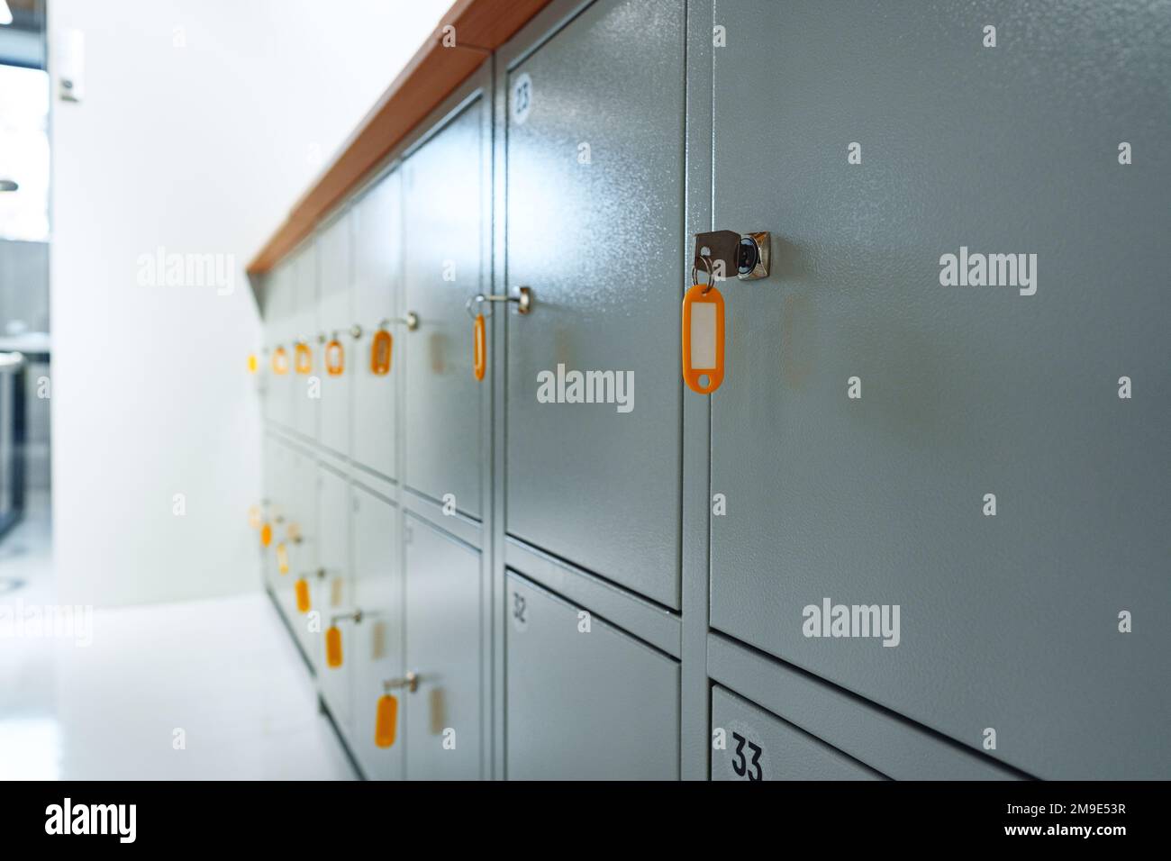 Gray locker with key for safety in public facility Stock Photo - Alamy