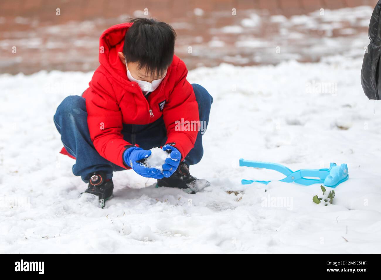 A child plays snow in Zhengzhou City, central China's Henan Province ...