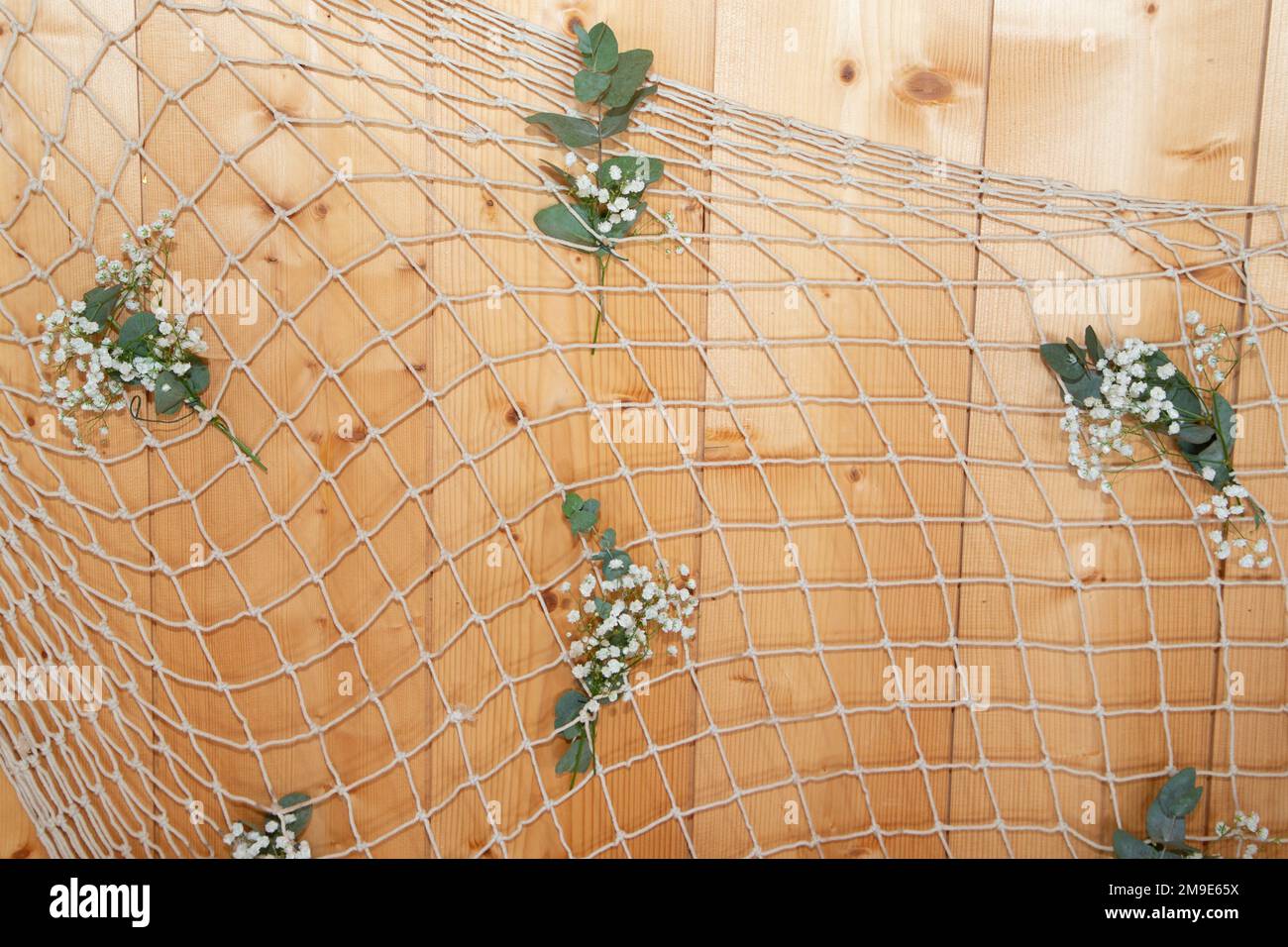 green white flower leaves with fisherman net to background wooden wall ...