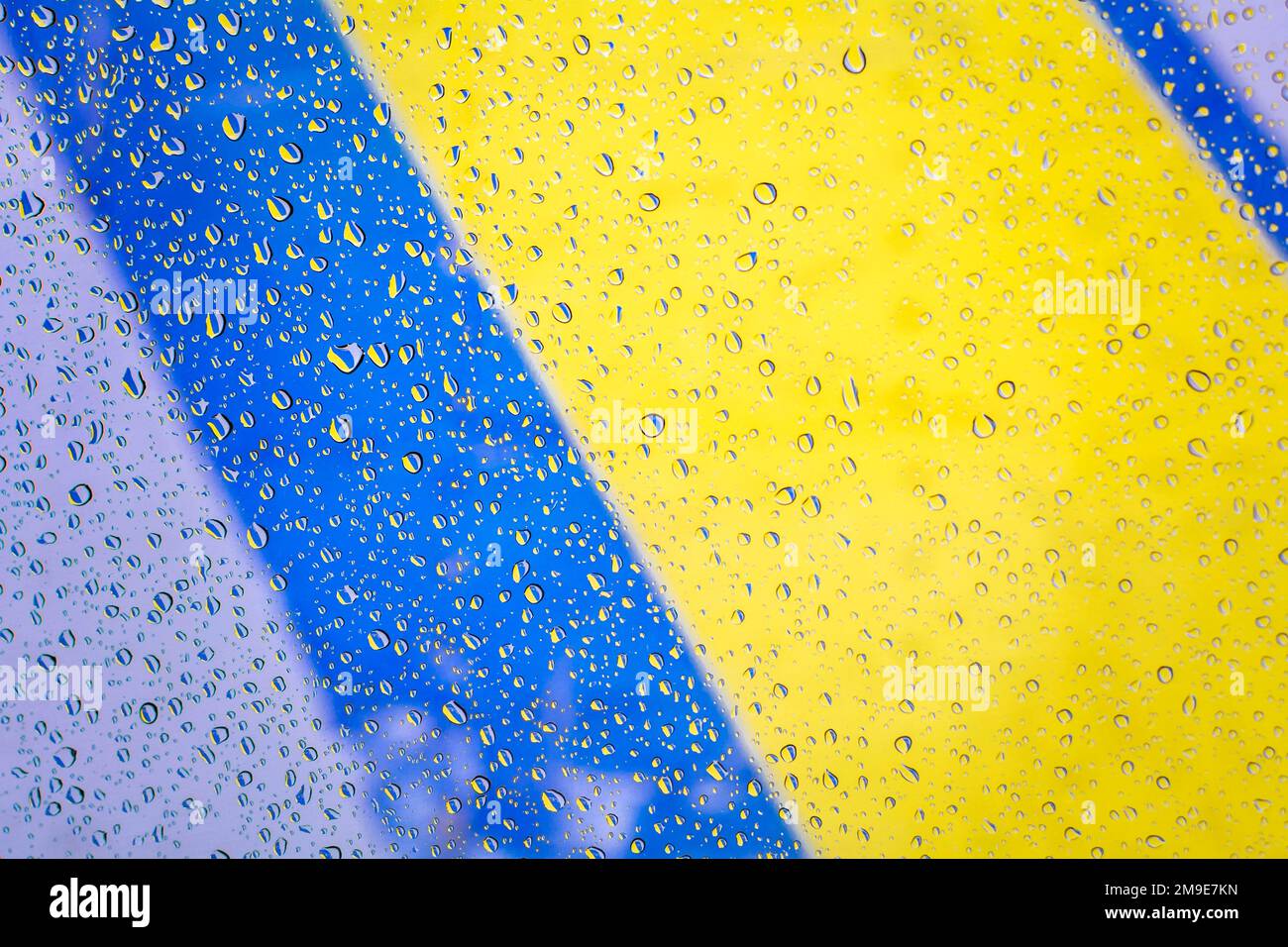 Raindrops with ukraine flag background, raindrops on glass with colors ...