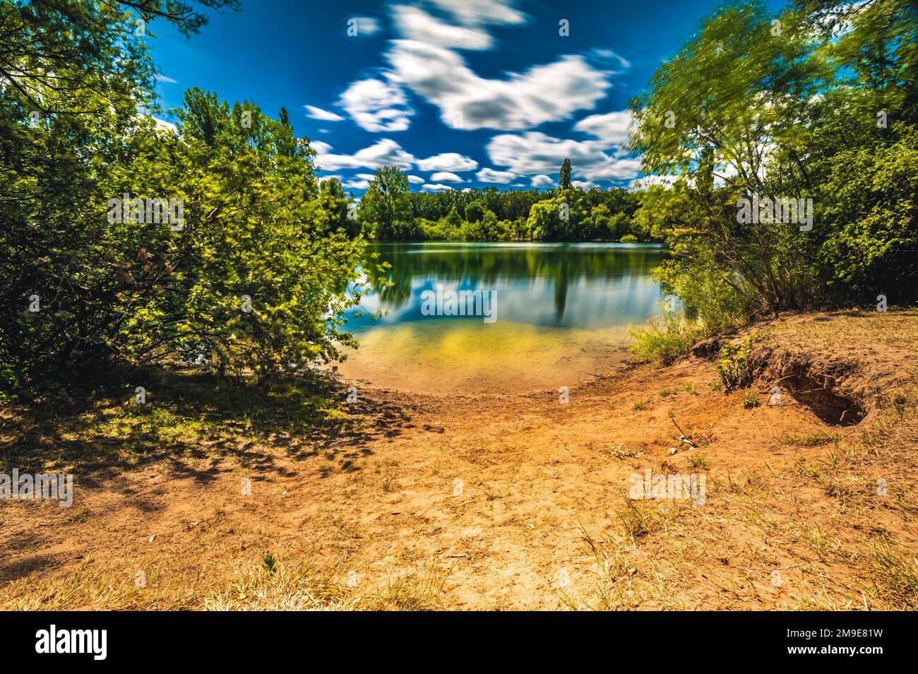 Long exposure with blue sky and scattered clouds at the Kiesteich ...