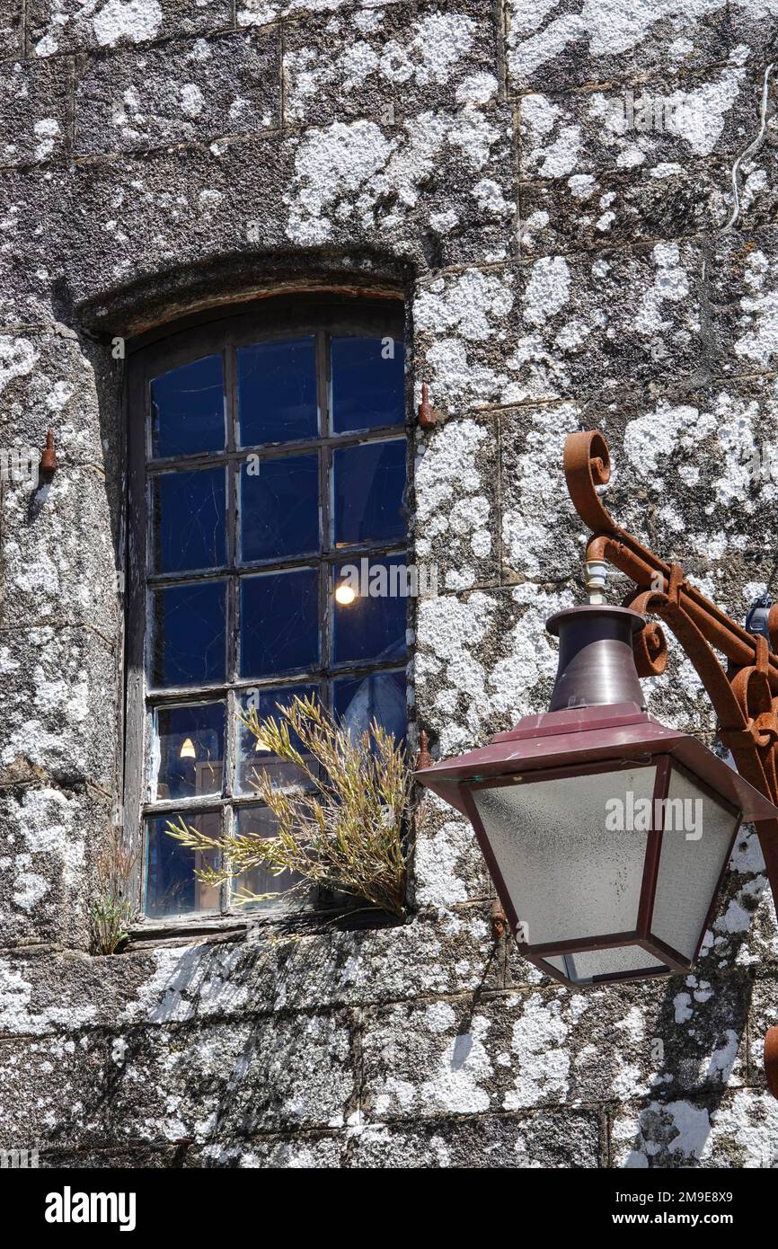 Window and street lamp on an old stone house, Locronan, awarded as one ...