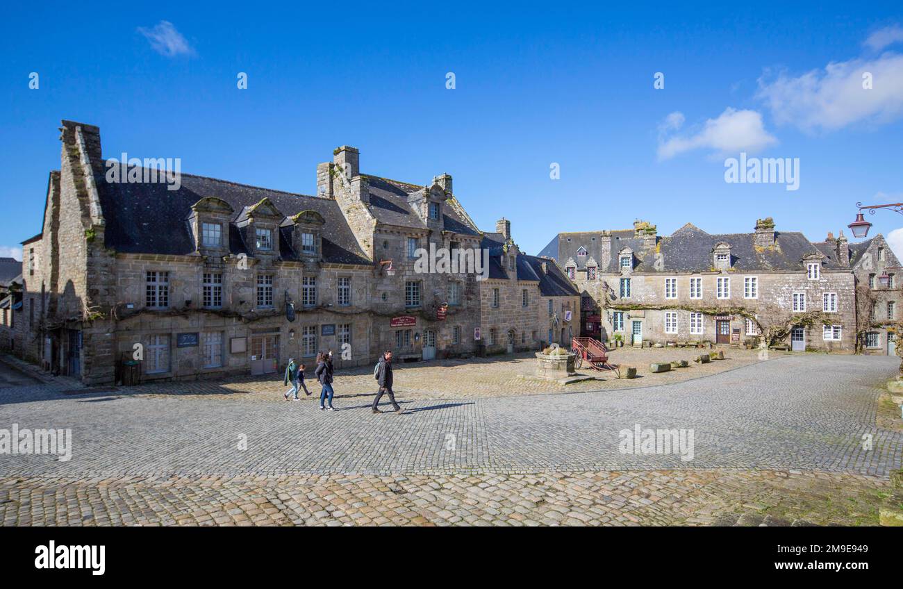 Village square with old horse-drawn cart and fountain, Locronan, named ...