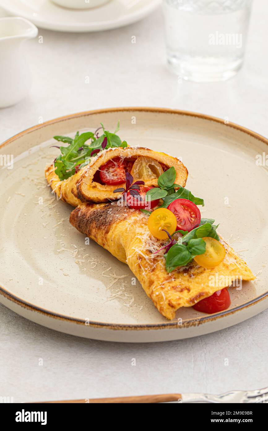 Omelette with tomatoes, basil and parmesan Stock Photo - Alamy