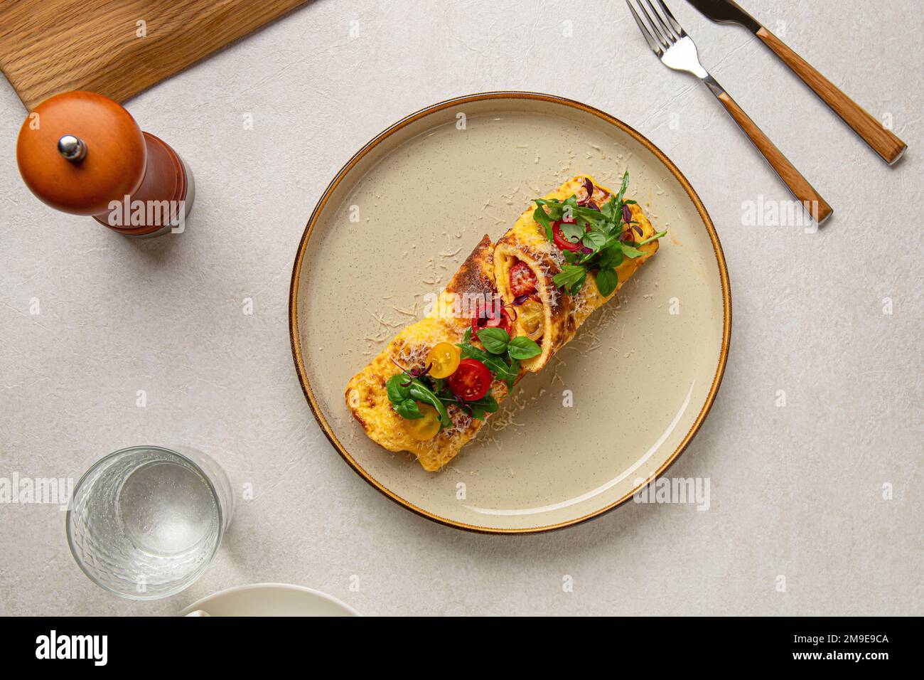 Omelette with tomatoes, basil and parmesan Stock Photo - Alamy