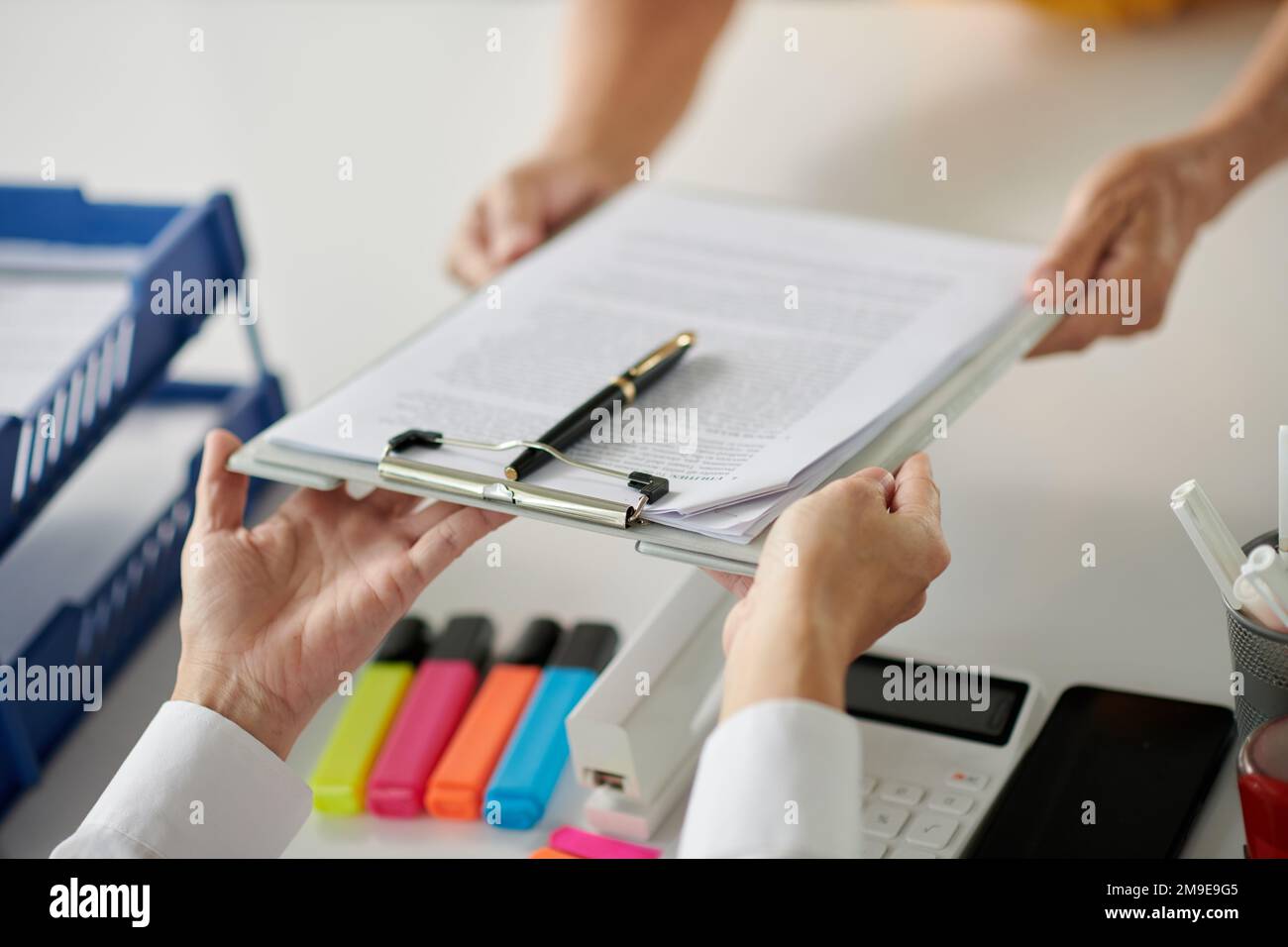 Hands of senior woman giving signed document to social worker Stock ...
