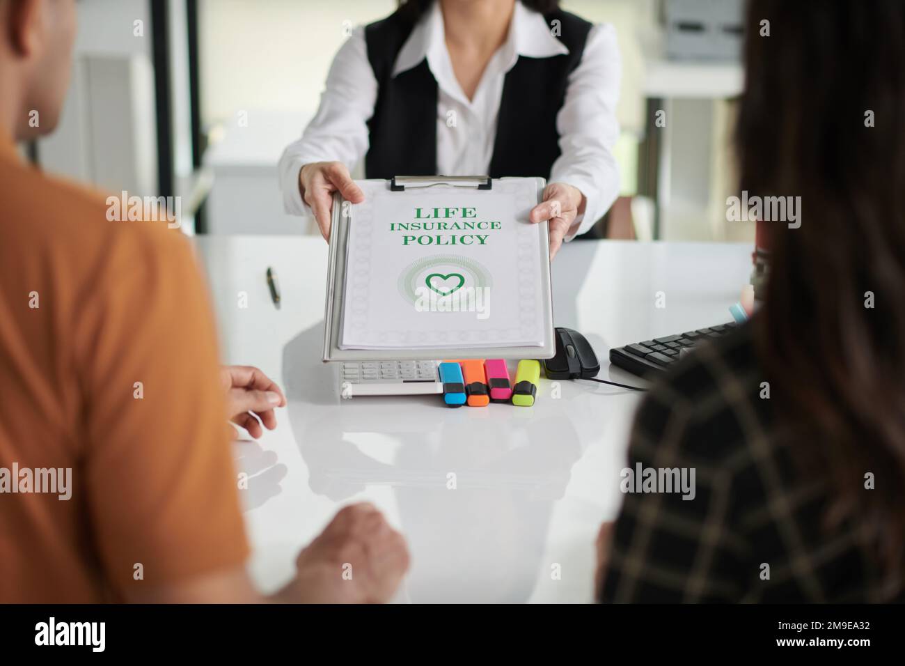 Agent giving life insurance policy to young couple Stock Photo - Alamy
