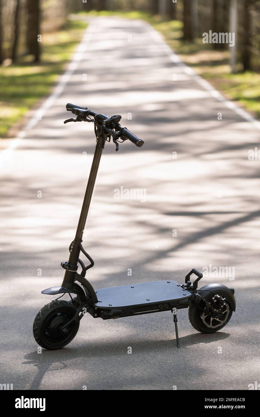 Black Electric scooter standing on the running board on the street ...