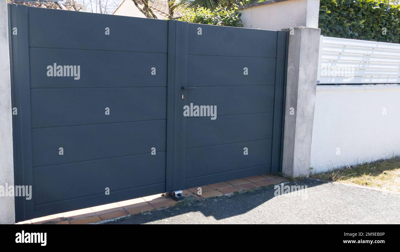 Aluminum door home in dark gray gate portal of suburb house Stock Photo ...