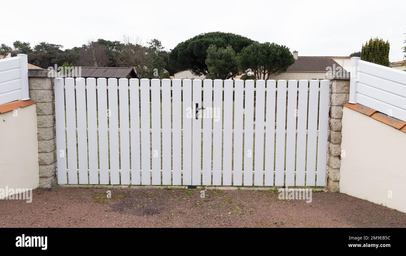 high gate suburb white house gate with slats Stock Photo - Alamy