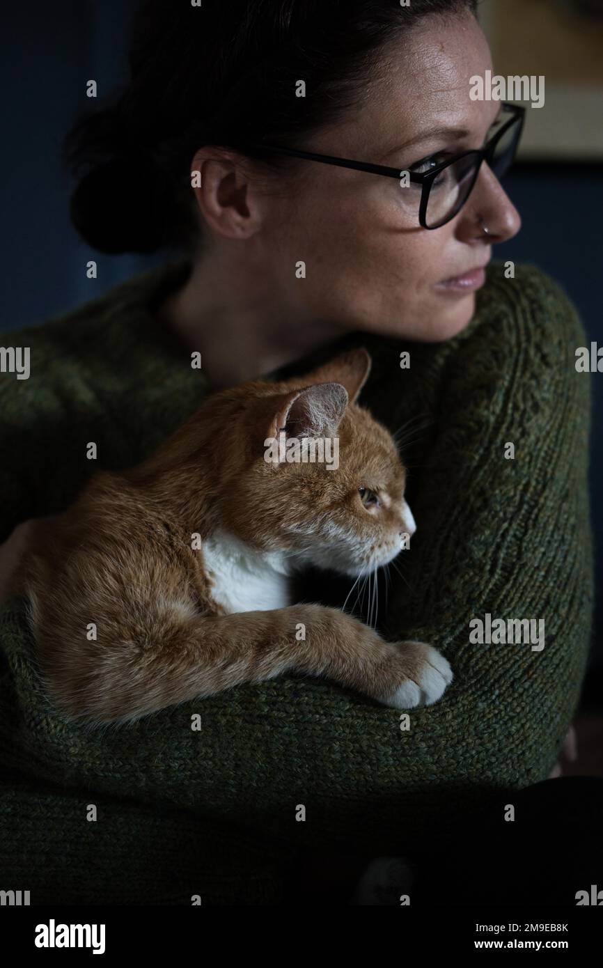 Portrait of a woman holding a cat, interior view Stock Photo - Alamy