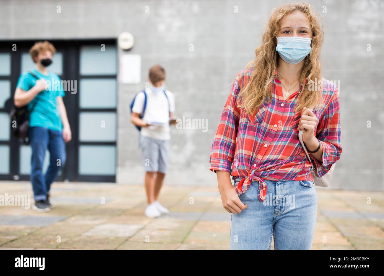 Teenager girl in mask at school building Stock Photo - Alamy