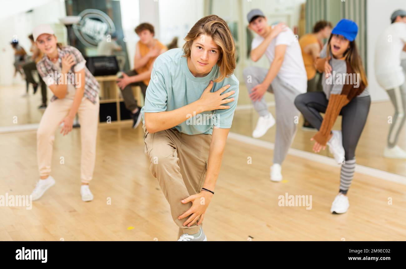 Teenage krump dancer dancing with teenagers in choreographic studio ...