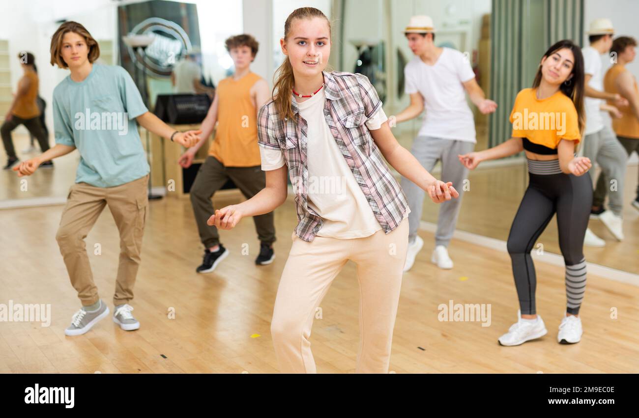 Smiling teenage girl practicing vigorous dance in studio Stock Photo ...