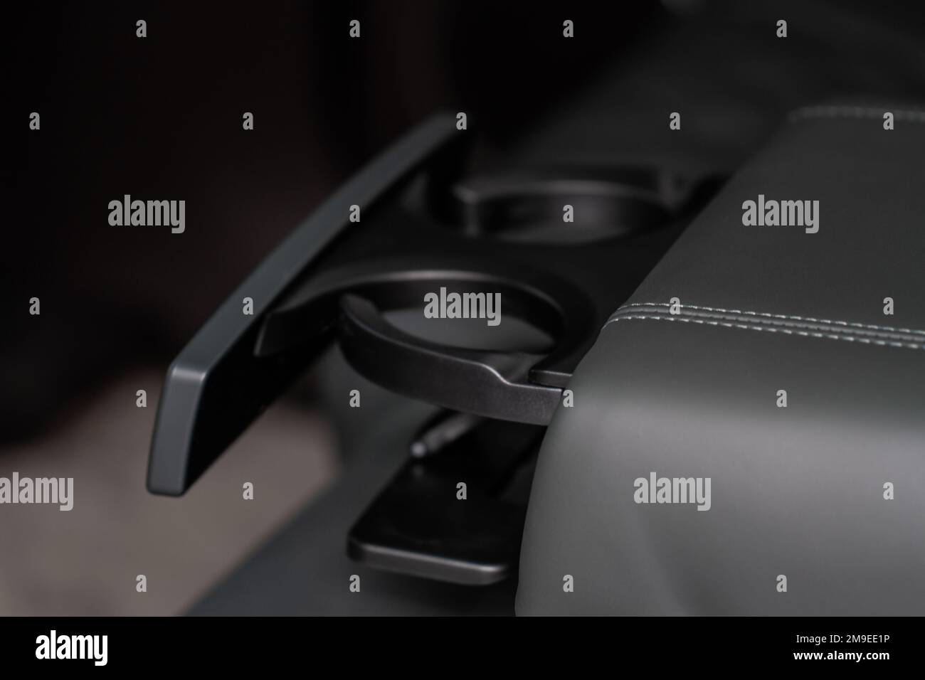 Modern car cup holder for rear seats row. Armrest in the car with cup ...