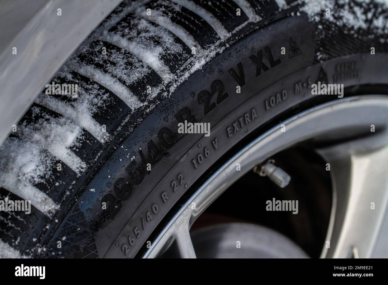 Close up view of snowy tire with tire width, height and wheel diameter ...