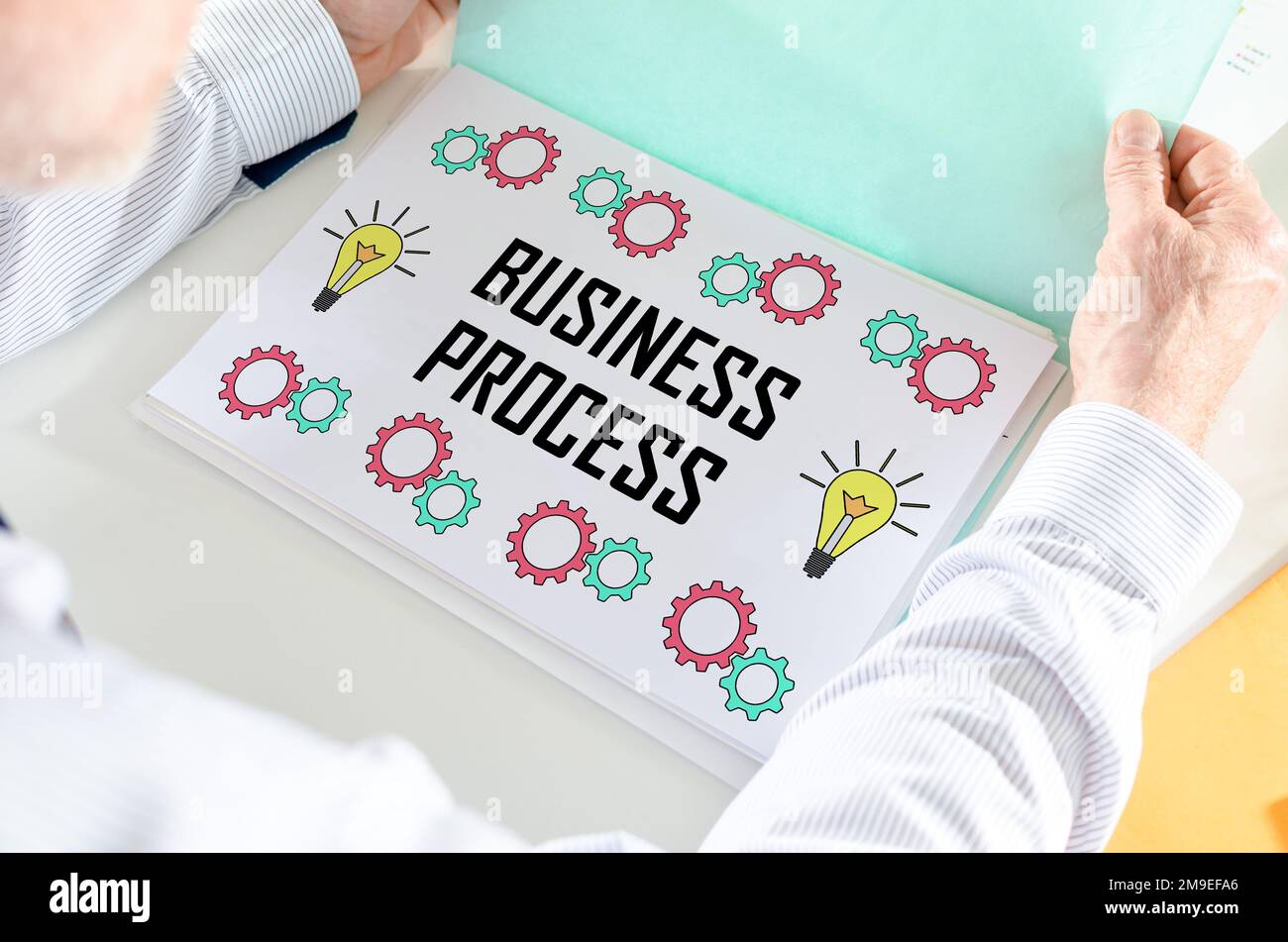 Man holding a file with business process concept Stock Photo - Alamy