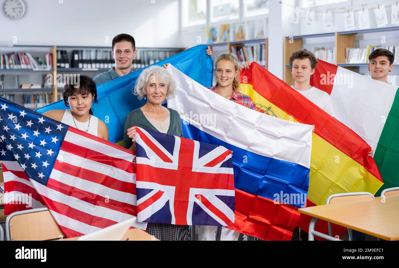 Group of young teenagers people holding international flags of many ...