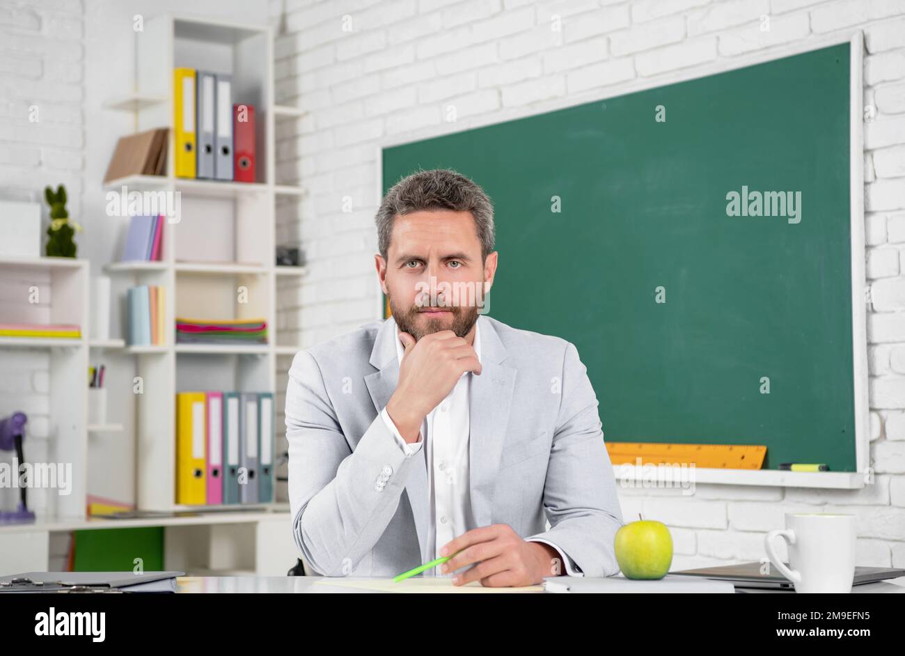 serious school teacher in classroom at blackboard Stock Photo - Alamy