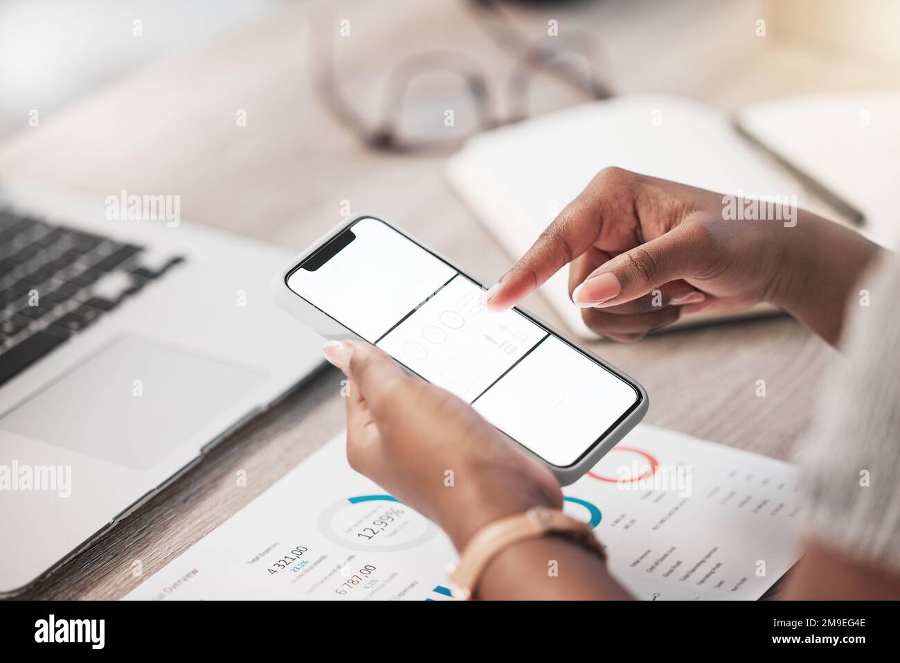 Staying on task with each tap. an unrecognisable businesswoman using a ...