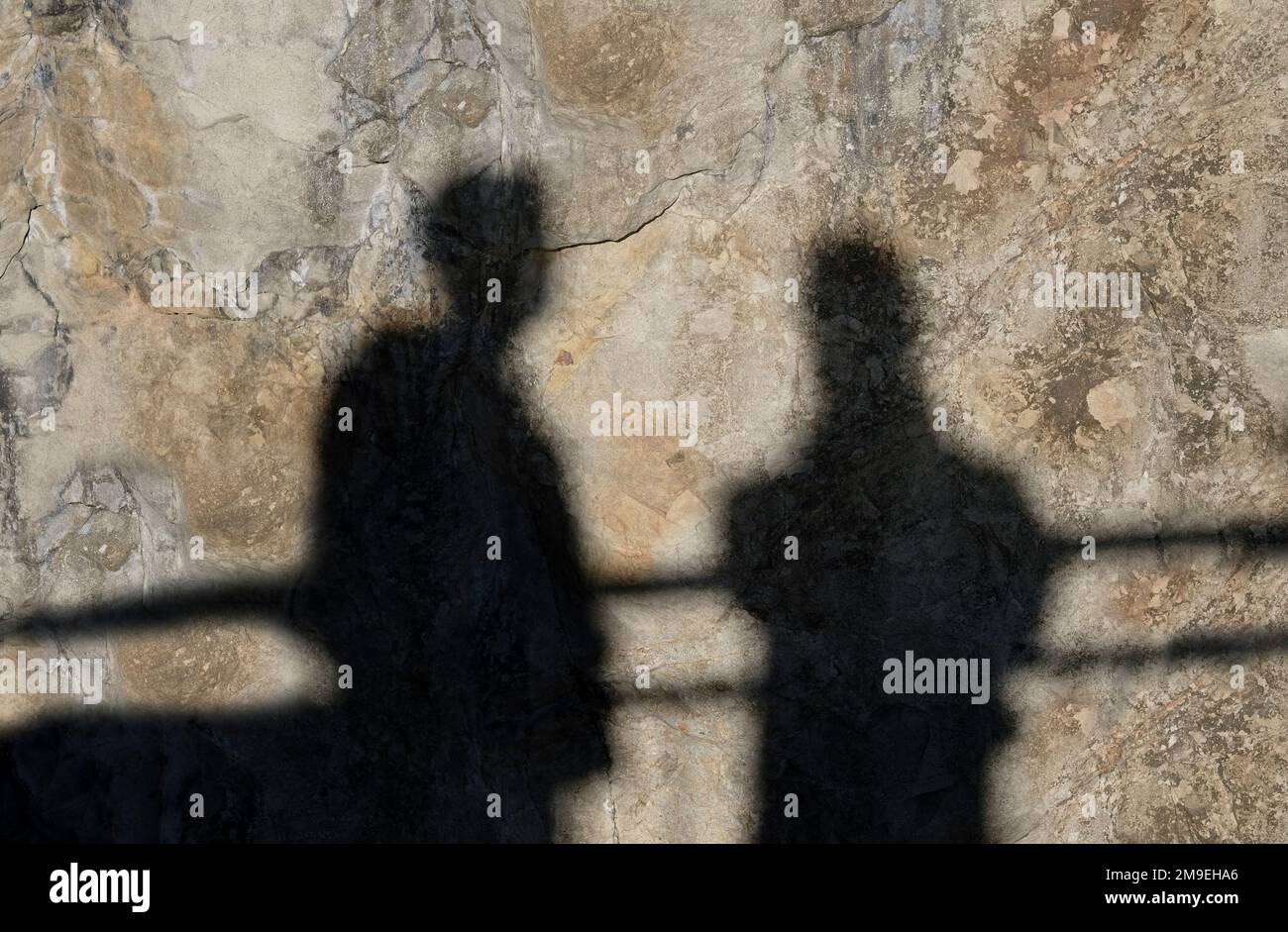 Shadow of two men on a cliff Stock Photo - Alamy