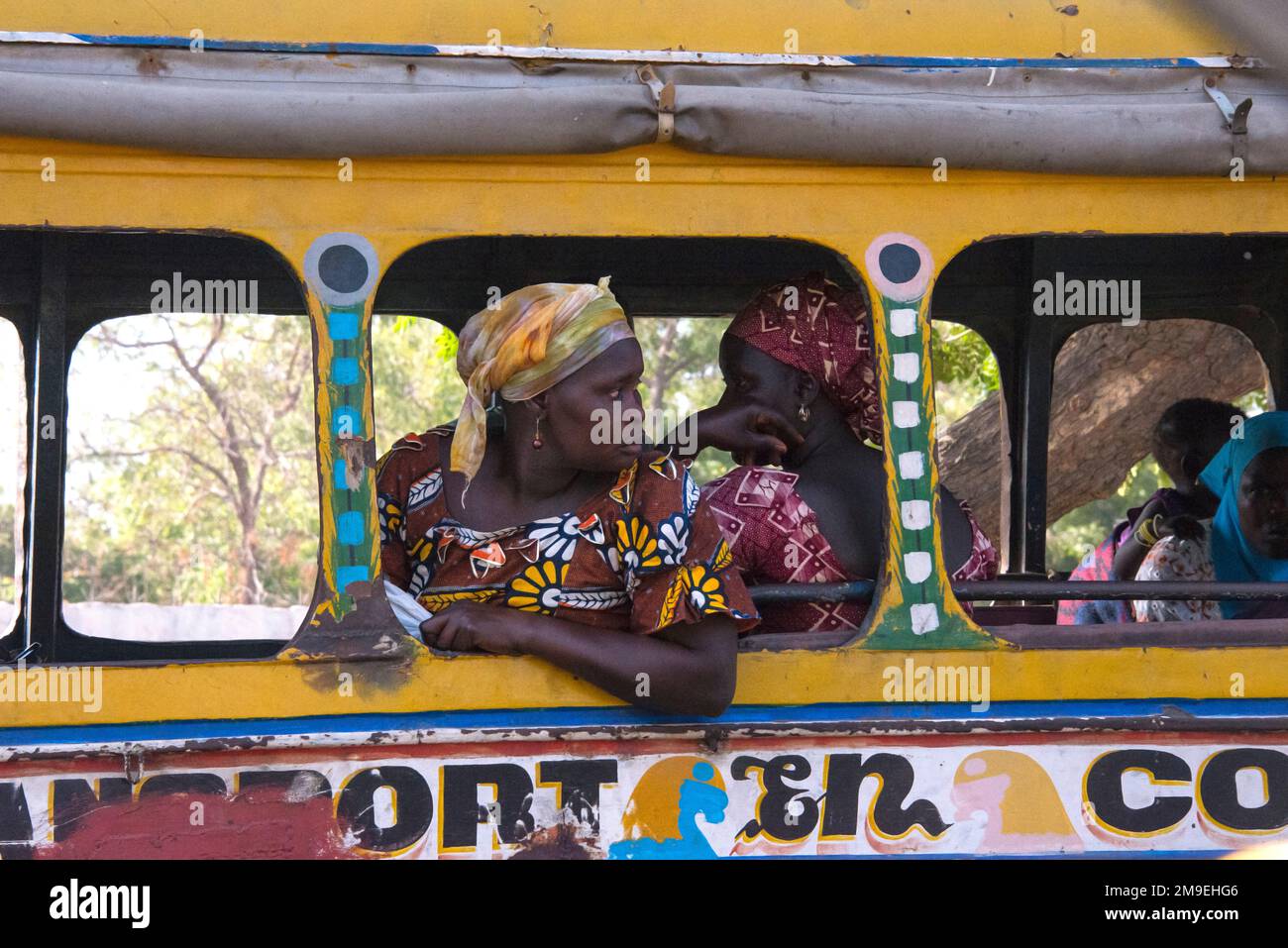 Women leaning out of the windows of a decorated bus in the city of Dakar, Senegal Stock Photo ...