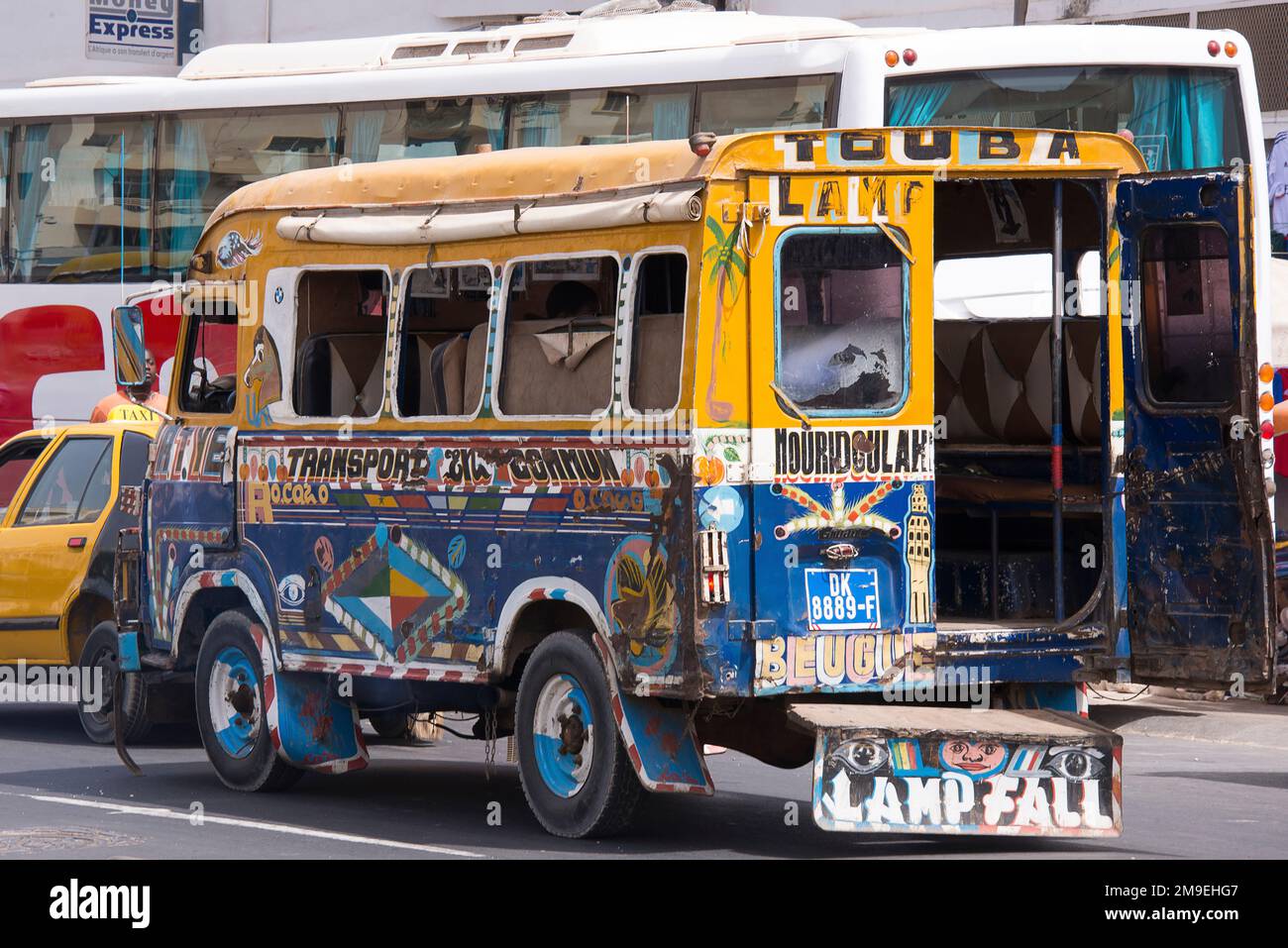 Decorated bus driving through the streets of the city of Dakar, Senegal ...