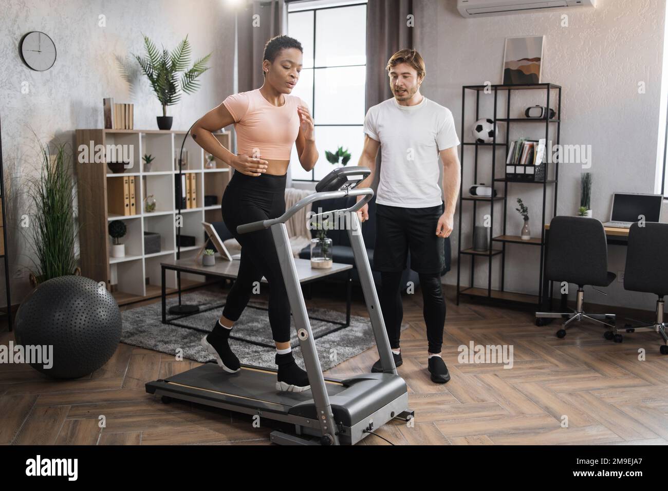 Home fitness workout sporty woman and man training on running track ...