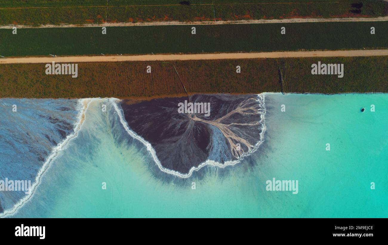 Top down aerial view over natural texture - abstract industrial lake ...