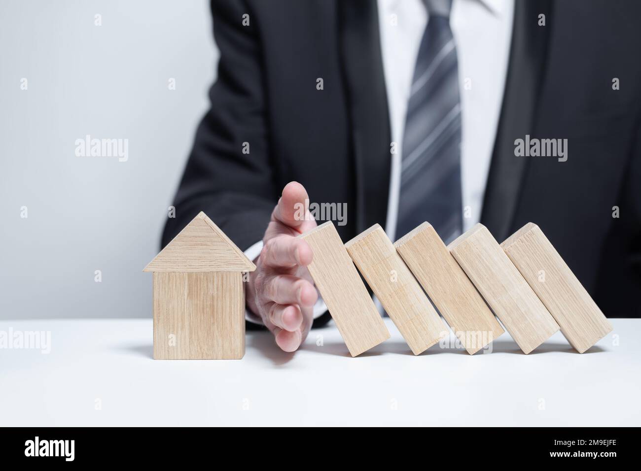 Wooden blocks under business hand protection, domino, insurance safety ...