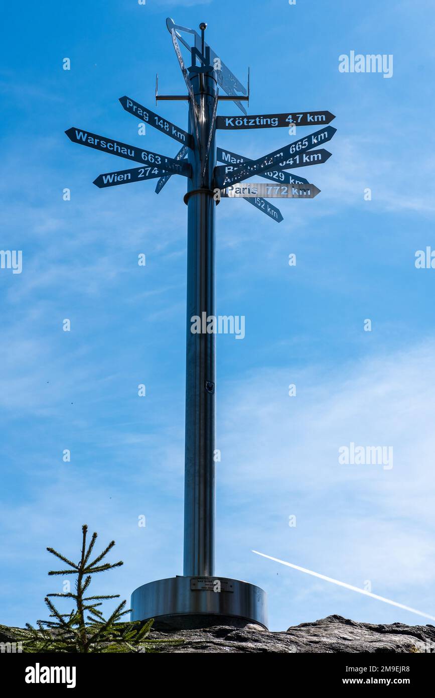 A vertical shot of a signpost indicating the directions and distances ...