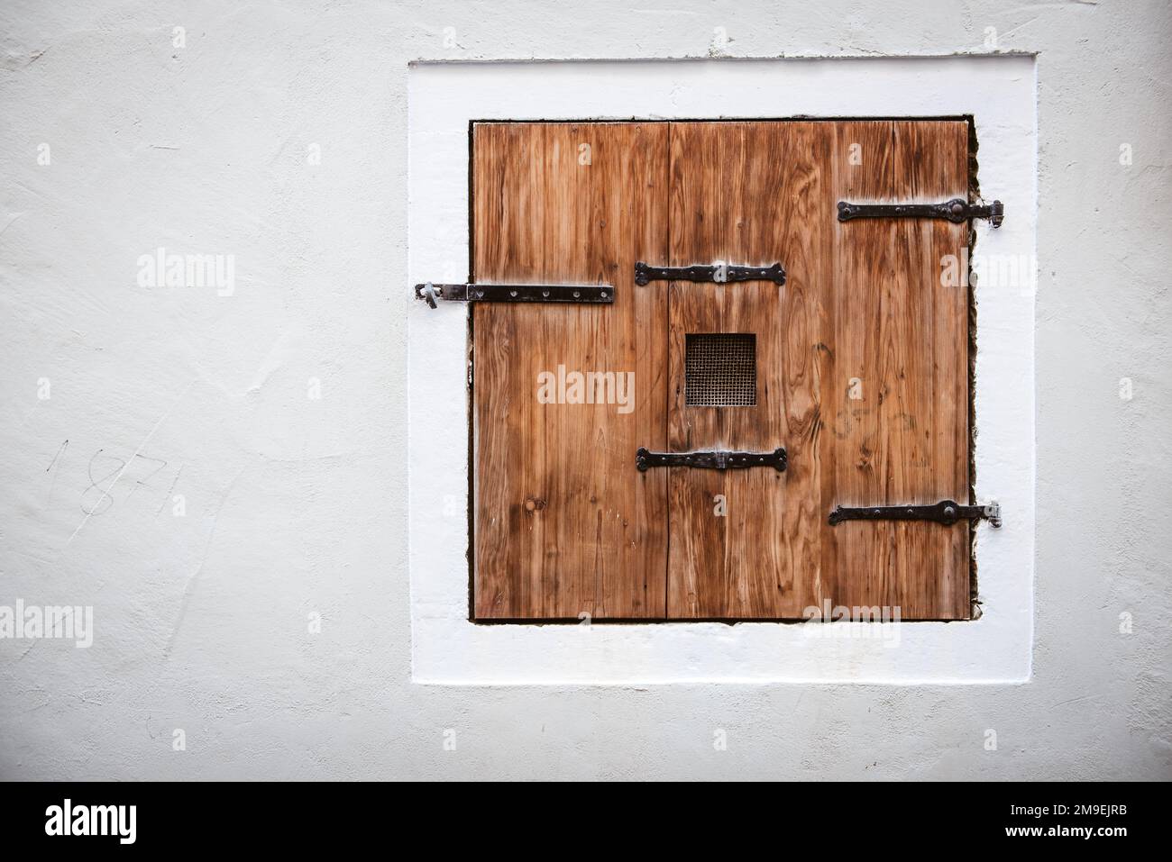 An old wooden hatch on a white wall Stock Photo - Alamy