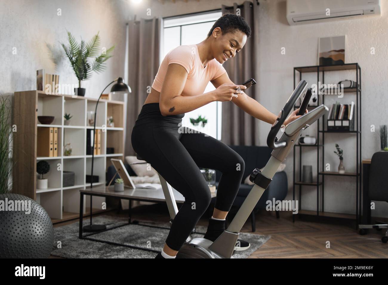 Smiling beautiful african american sports woman in sportswear writing ...