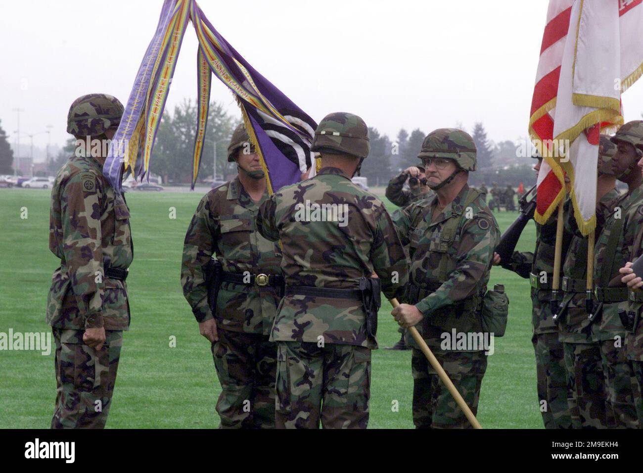Command Sergeant Major Johnny J. Austin presents the colors to the out ...
